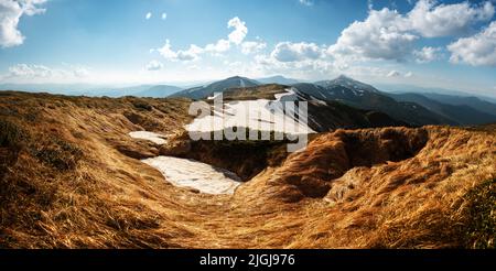 View of the grassy hills with orange tussocks and snowy mountains on ...