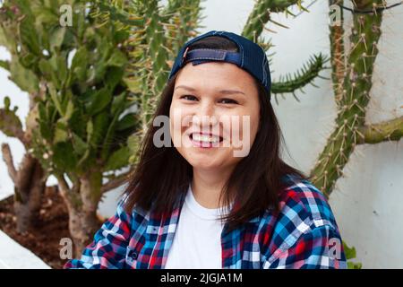 yound pretty american woman siting smiling among cactuses, lifestyle ...