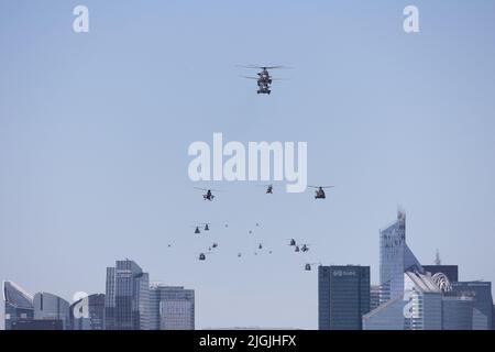Helicopters fly over La Defense business district during a aerial ...