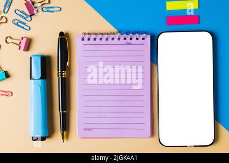 Composition of smartphone with copy space and school equipment on pink ...