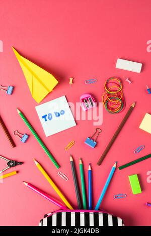 Composition of notebooks, paper plane and school equipment in striped ...