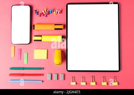 Composition of smartphone with copy space and school equipment on pink ...