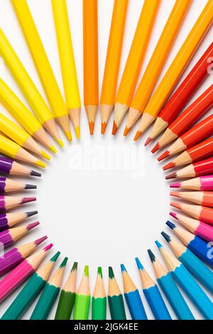 Vertical composition of colorful crayons on blue surface with copy ...