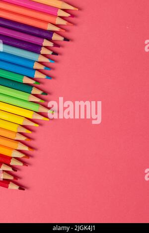 Vertical composition of colorful crayons on blue surface with copy ...
