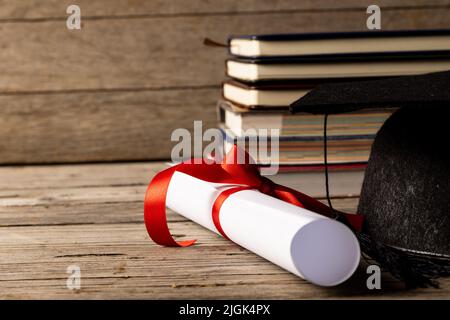 Image of stack of books and diploma on wooden surface Stock Photo - Alamy