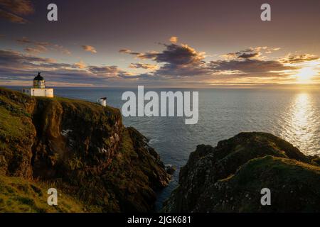 St Abbs lighthouse at sunrise with golden hour light. located in ...