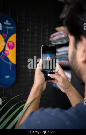 A boy looking at his phone. Dhaka, Bangladesh Stock Photo - Alamy