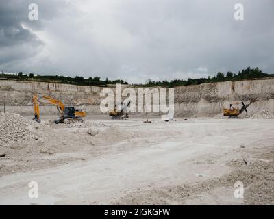 Chalk quarry pit with working excavators Stock Photo - Alamy