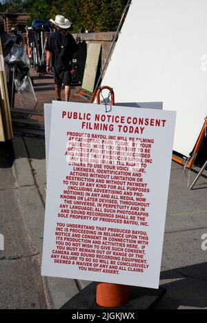 A notice posted near a filming location informs the public that filming ...