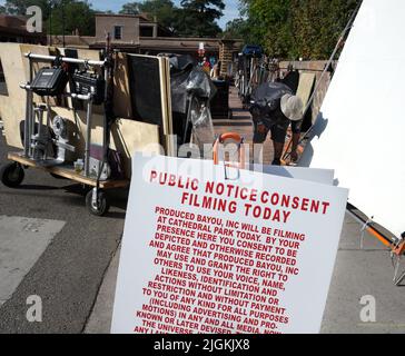 A notice posted near a filming location informs the public that filming ...