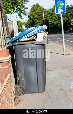 An overflowing cardboard bin of trash Stock Photo - Alamy