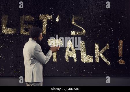 Rear view of a businessman with inscription Stock Photo - Alamy