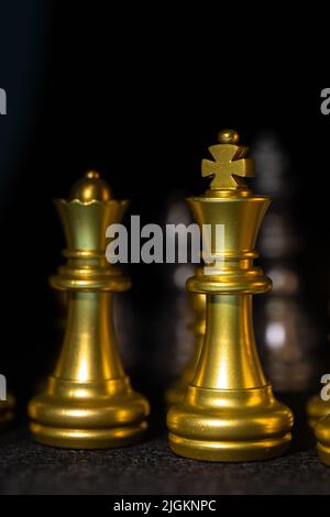 chess pieces in gold on a black background Stock Photo - Alamy