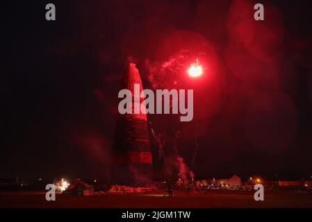 Fireworks explode over the Craigyhill bonfire in Larne, prior to it ...