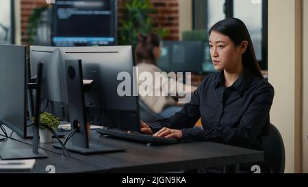 Programer writing algorithm focused on compiling source code sitting at ...