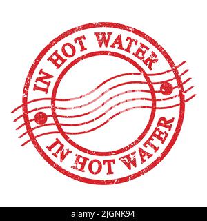 IN HOT WATER text written on green rectangle stamp sign Stock Photo - Alamy