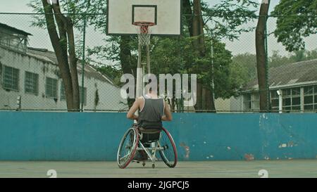 One paraplegic basketball player missing ball hoop outside ...
