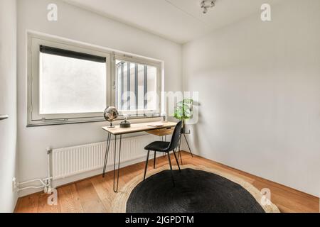 Comfortable chair placed near desk with computer monitors and ...