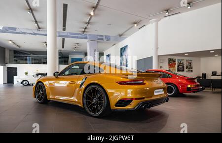 A picture of a red Porsche 911 Carrera 3.0 inside a dealership Stock ...