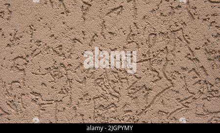 Light brown plaster wall with abstract stucco pattern texture surface ...
