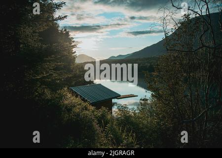 A mesmerizing shot of a seascape surrounded by mountains under the ...