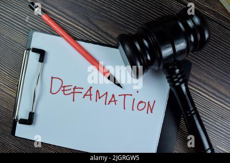 Concept of Defamation Law write on sticky notes with gavel isolated on ...
