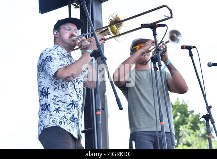 Tropidelic band members are shown performing on stage during a “live ...