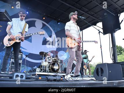 Tropidelic band members are shown performing on stage during a “live ...