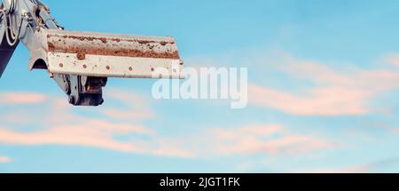 Excavator bucket raised up Stock Photo - Alamy