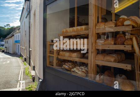 Stack of bread loaves are displayed in bakery shop window Stock Photo ...