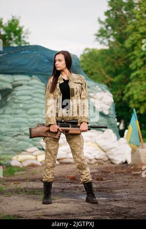 A beautiful girl with a weapon in her hands in the trench Stock Photo ...