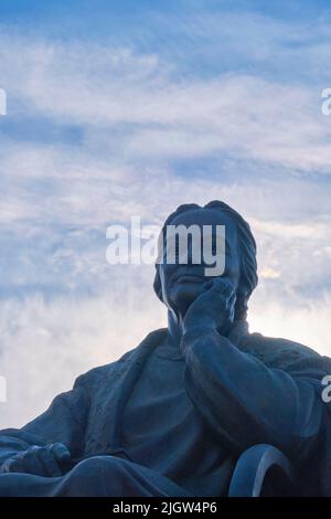 A bronze statue of a sitting Zulfiya, famous woman writer and poet. At ...