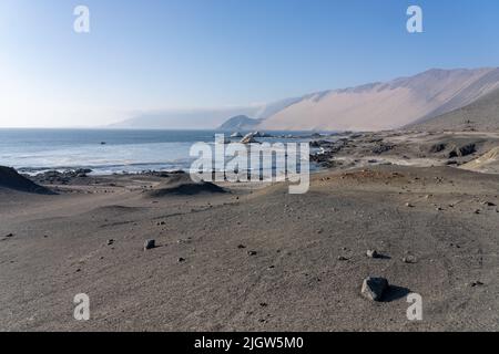 Giant sand dunes slope down from the Coast Range to the Pacific Ocean ...