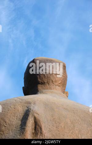 A bronze statue of a sitting Muqimiy, famous writer and critic. At ...
