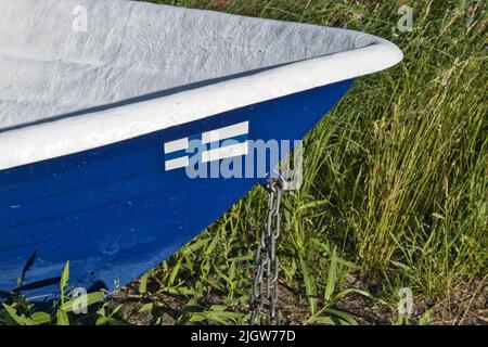 Finnish flag painted on a bow of a small boat Stock Photo - Alamy