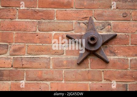 decorative and structural metal bolted stars on older brick building ...
