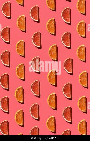 Pattern made of colorful candied fruits orange lemon on coral ...