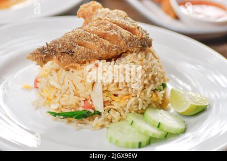 stir fried rice or fried rice with fried fish topping and sauce Stock ...