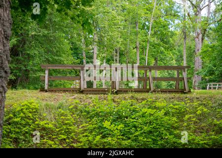 A wooden pedestrian footbridge leads to autumn colors and fall foliage ...