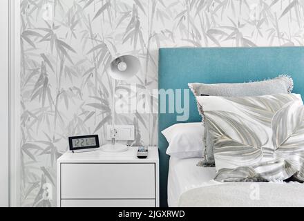 Cozy bedroom interior with grey pillows, white linens, wooden headboard ...
