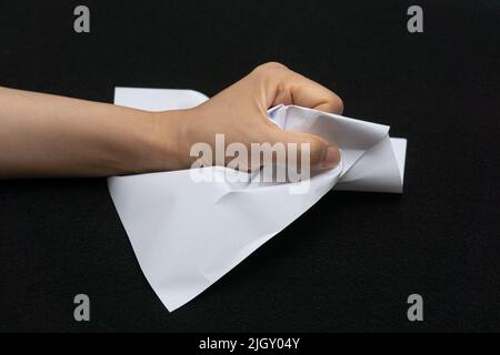 A mess of crumpled paper trash on a black background Stock Photo - Alamy