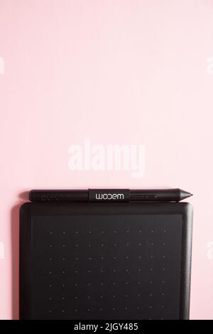 Tver, Russia - February 3, 2020 Top view of Wacom graphic tablet on red ...