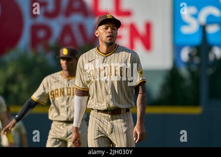 San Diego Padres' José Azocar is seen through a glove on the dugout ...