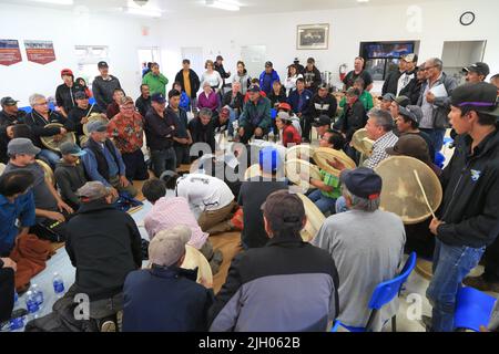 Indigenous Dene men playing drums and traditional handgames in the ...