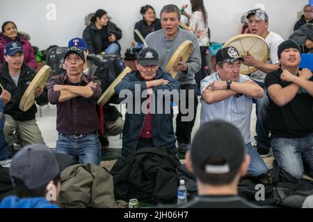 Dene men drumming and playing traditional hand games in the northern ...