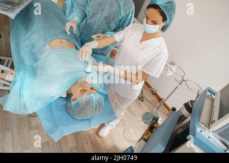 Anesthesiologist and patient during an operation with general ...