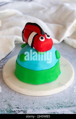 Design cake. Design cake with fish figures on a stone background ...
