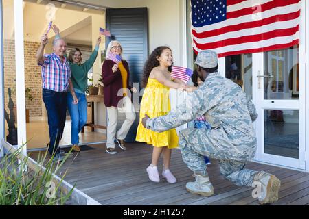 Multiracial excited multigeneration family with flag of america ...