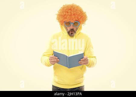 Senior student in funky wig read school book in sunglasses with ...