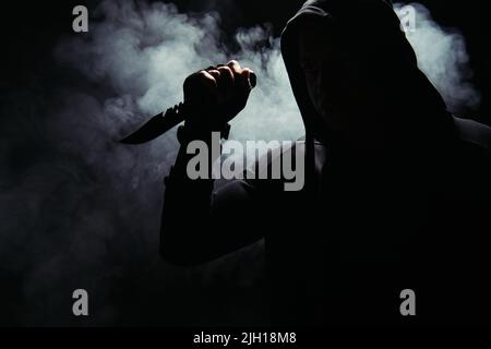 African american bandit in hood holding baseball bat on black ...
